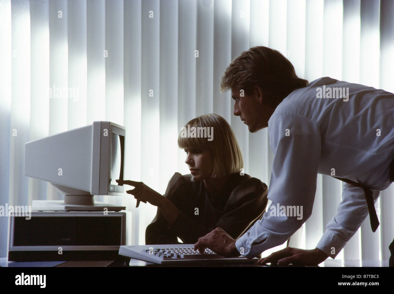 Executives at work in office setting with computer Stock Photo - Alamy