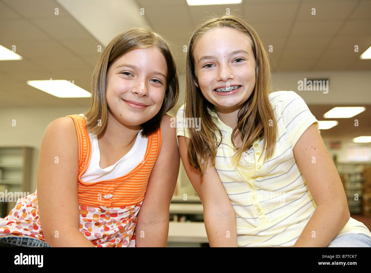 Two cute adolescent girls in the school library Stock Photo - Alamy