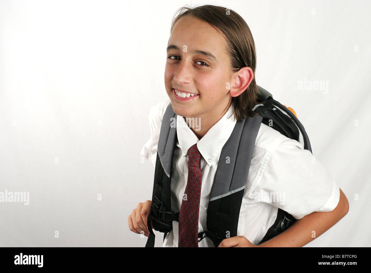 a cute school boy in his uniform with a back pack room for text Stock ...
