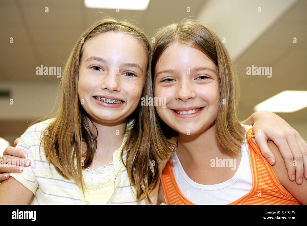 Two cute adolescent girls together in school Stock Photo - Alamy