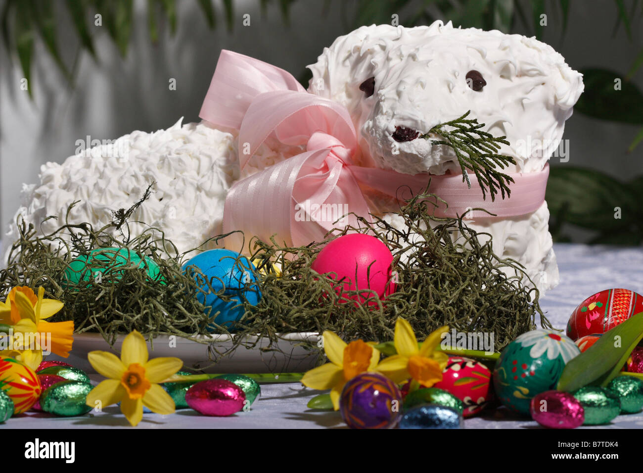 Spring Easter Holiday with a traditional lamb cake and colored eggs on ...
