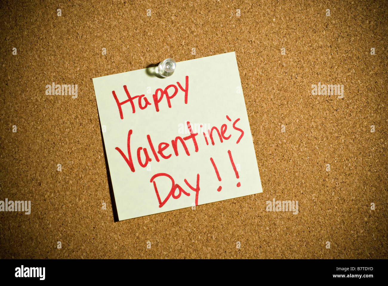 Post it note or memo on a cork board that says Happy Valentine's Day ...