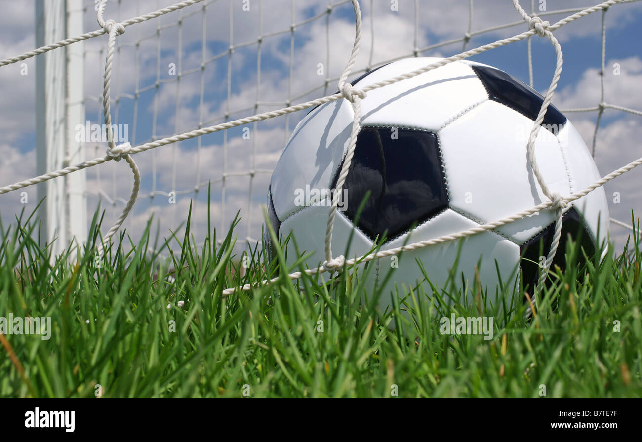 Soccer goal in goal net against blue sky Stock Photo - Alamy
