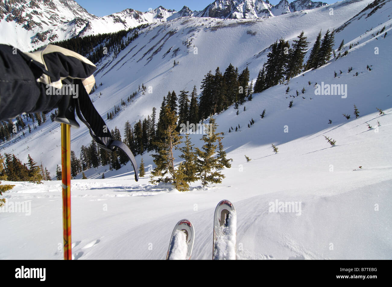 a skier about to drop into a steep chute in the backcountry near ...