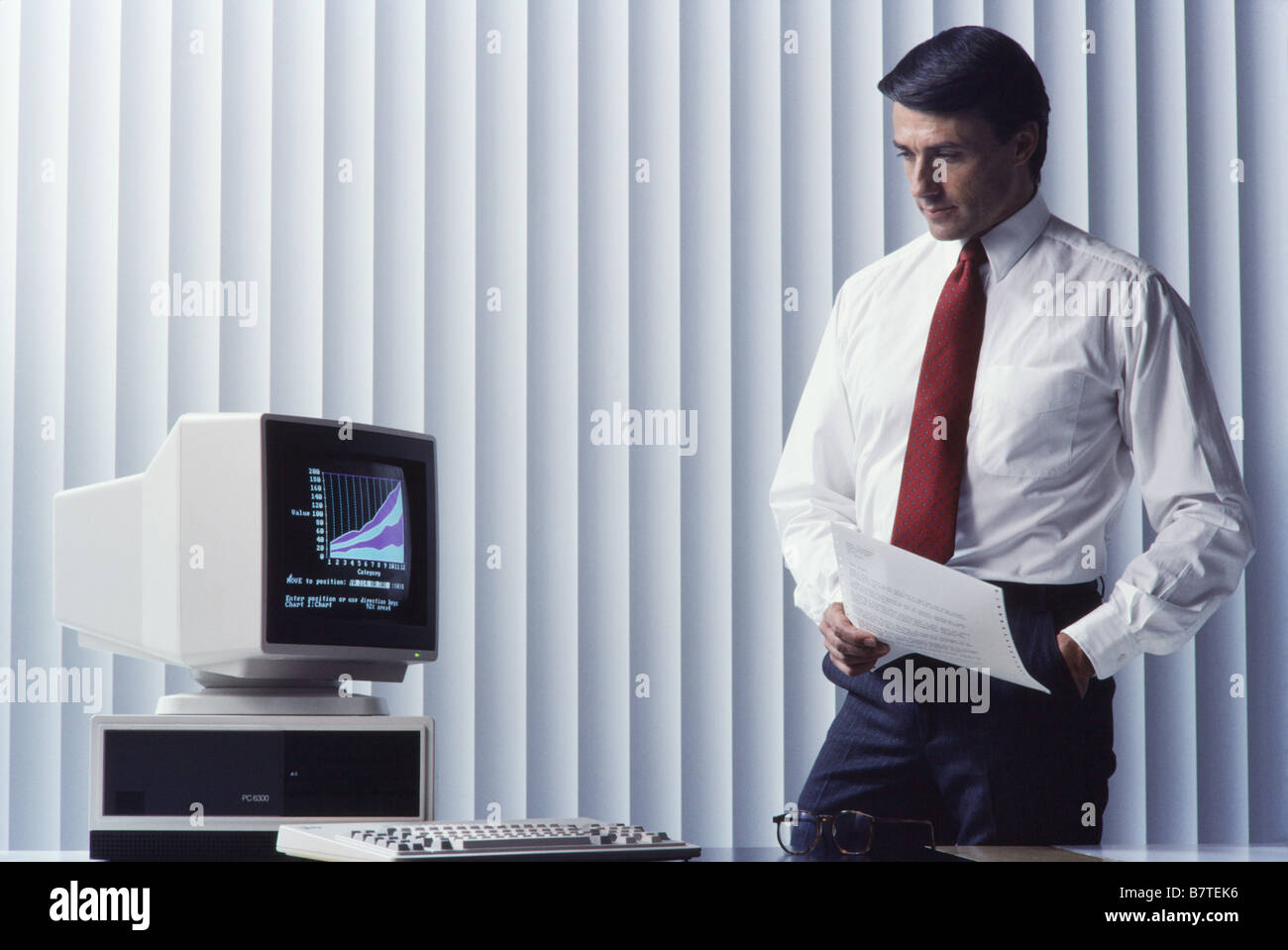 Executives at work in office setting with computer Stock Photo - Alamy