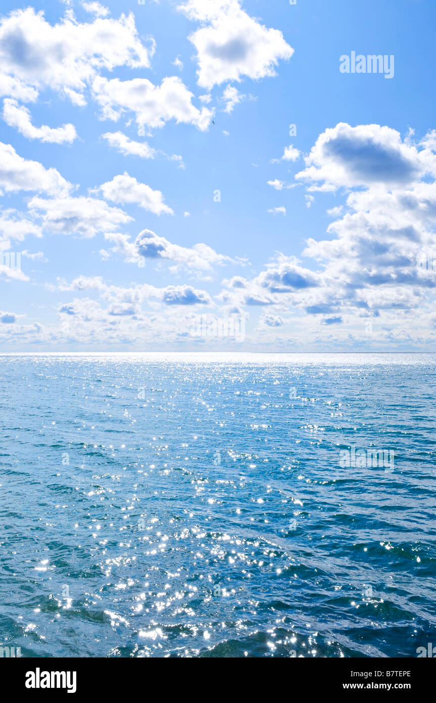 Blue ocean water and sunny sky background Stock Photo - Alamy