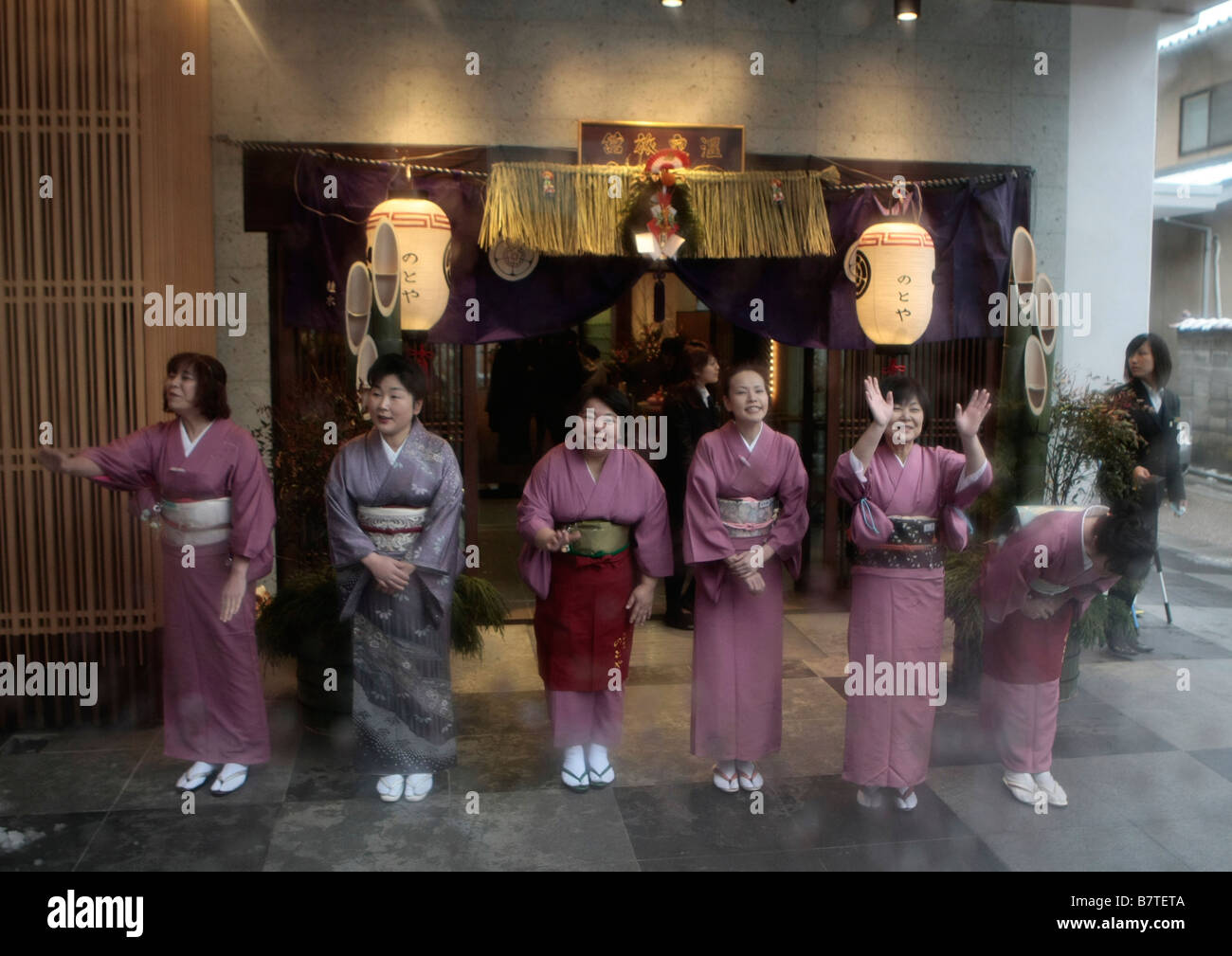Hotel staff wave farewell to guests as they leave their hotel in ...