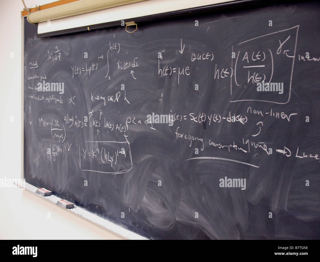 Algebraic and calculus equations in chalk on a blackboard used in a ...
