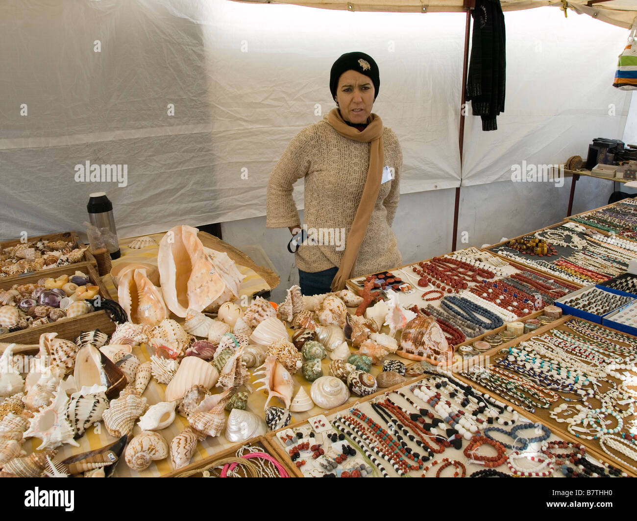 A trader selling sea shells and jewellery at the Sunday Market in ...