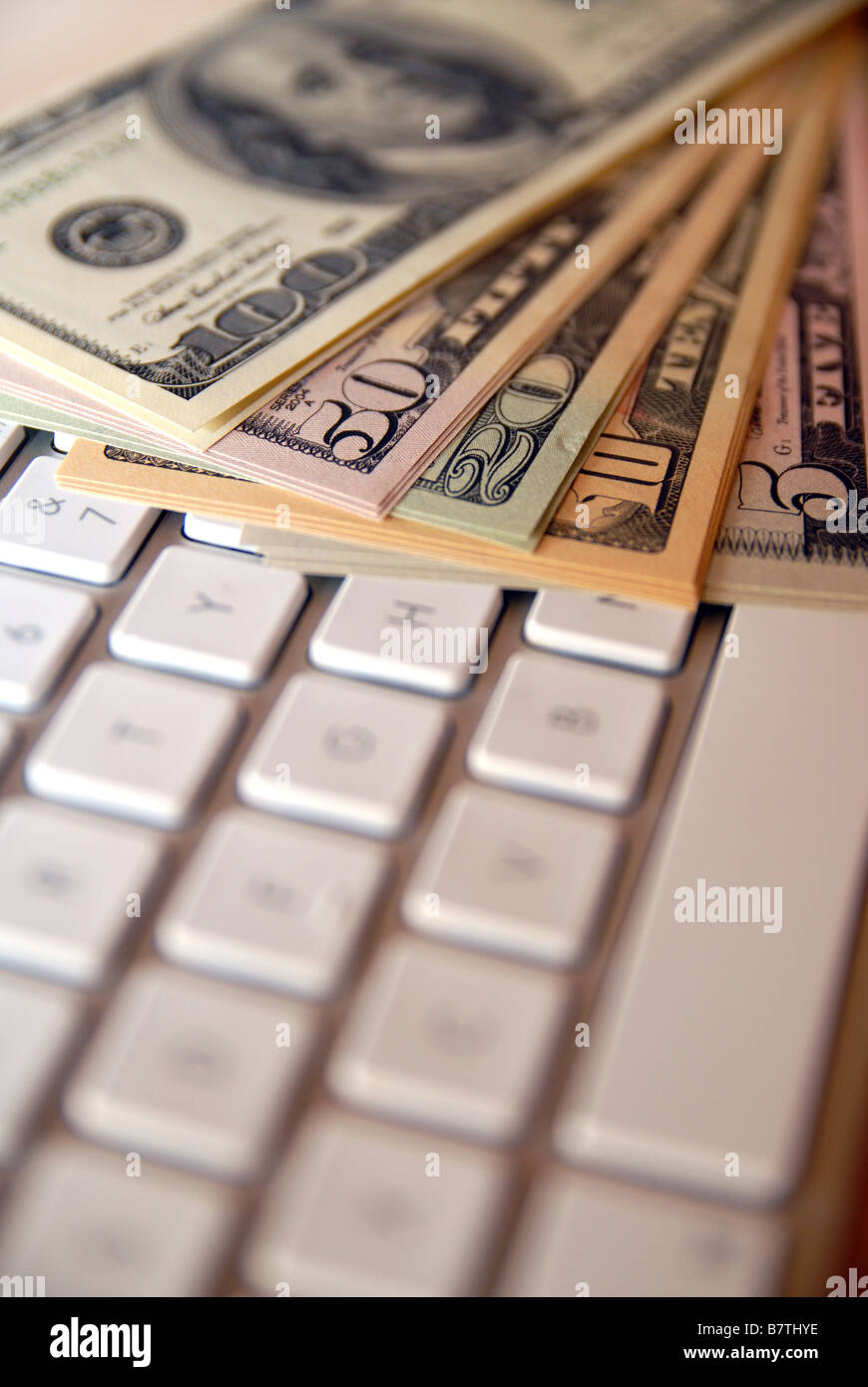 Dollar bank notes / currency / money layed out on a computer keyboard ...