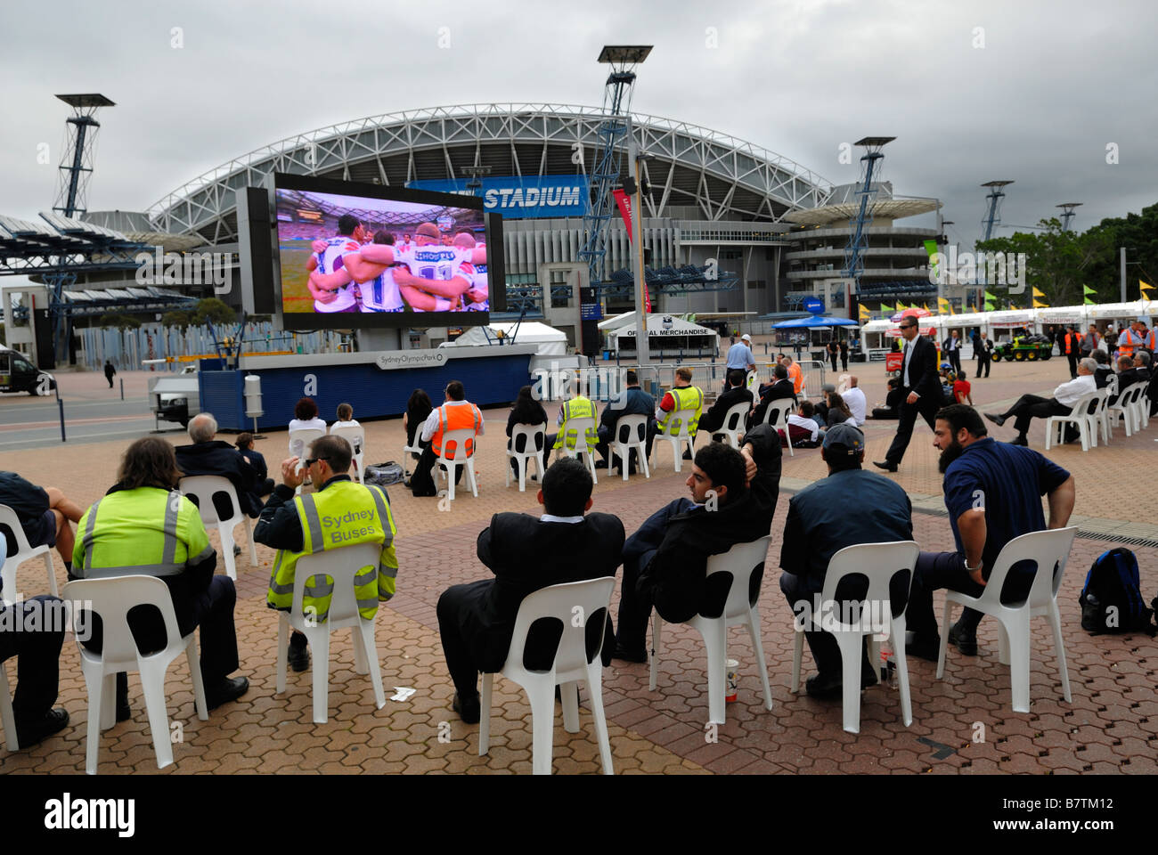 Spectators watching the 2008 NSW Rugby League Grand Final on large ...