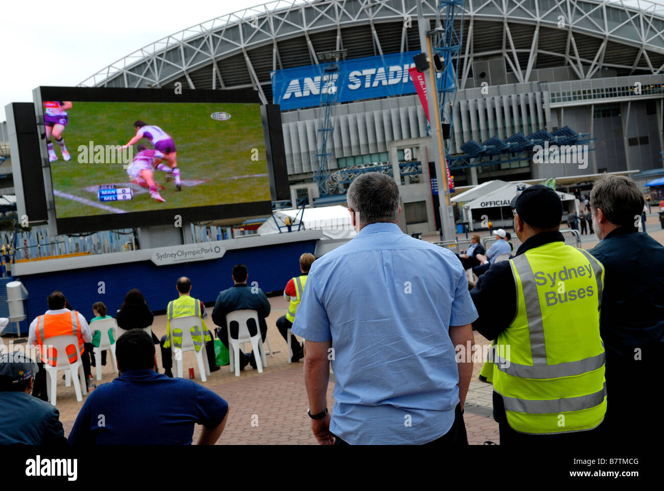 Spectators watching the 2008 NSW Rugby League Grand Final on large ...