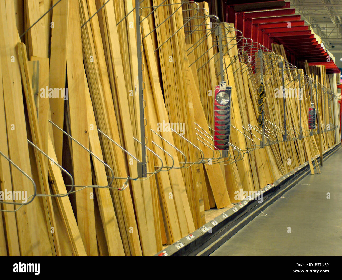 Various lengths and cuts of lumber on display for sale at a home ...