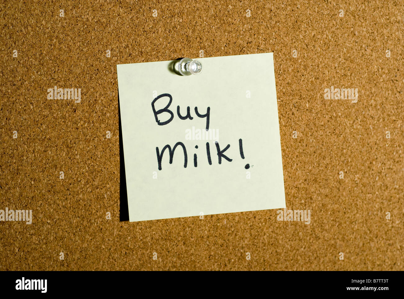 Post it note or memo on a cork board that says buy milk Stock Photo - Alamy