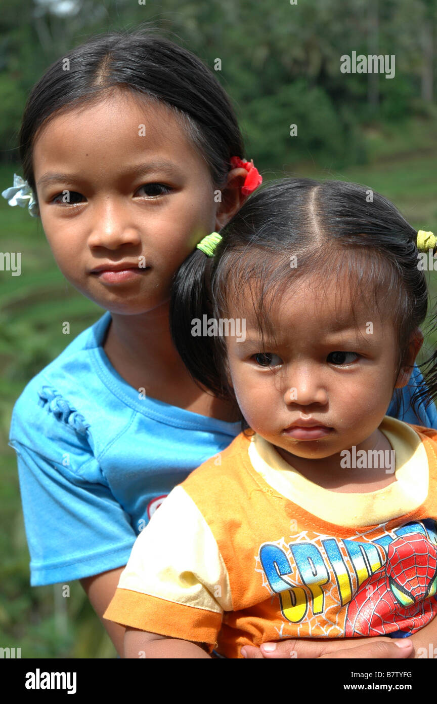 Two children in Bali pose for the camera Stock Photo - Alamy