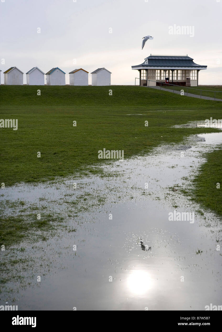 Beach Huts, Sun and Pavillion, Reflected in Flood Water Stock Photo - Alamy