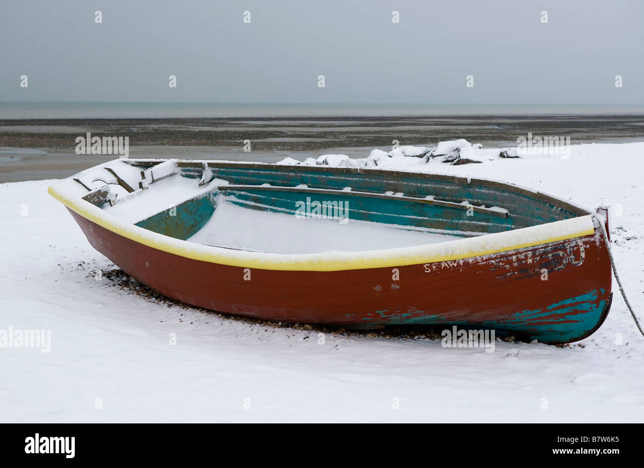 Fishing Boat on a Beach in Snow Stock Photo - Alamy