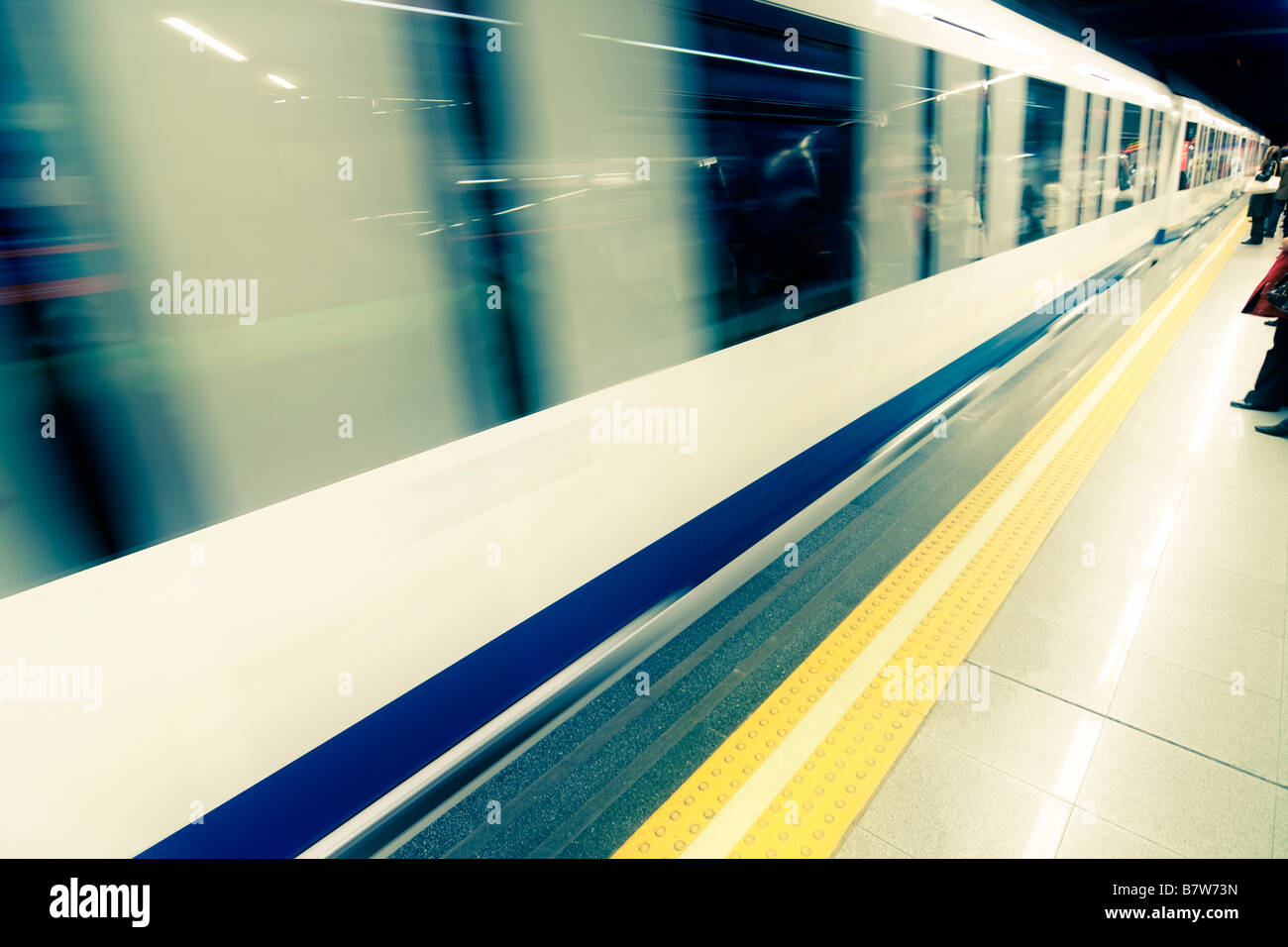 Subway station with people waiting Stock Photo - Alamy