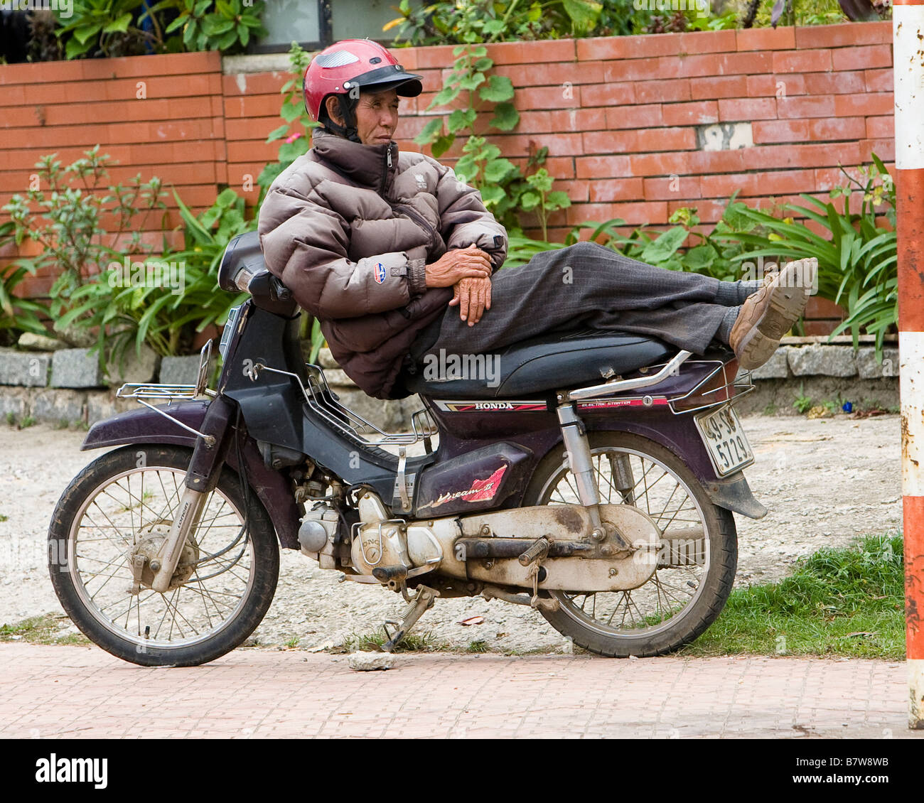 man lying on motorbike Stock Photo - Alamy