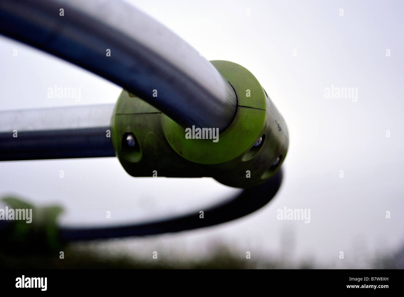 A curved metal tube with a yellow joint Stock Photo - Alamy