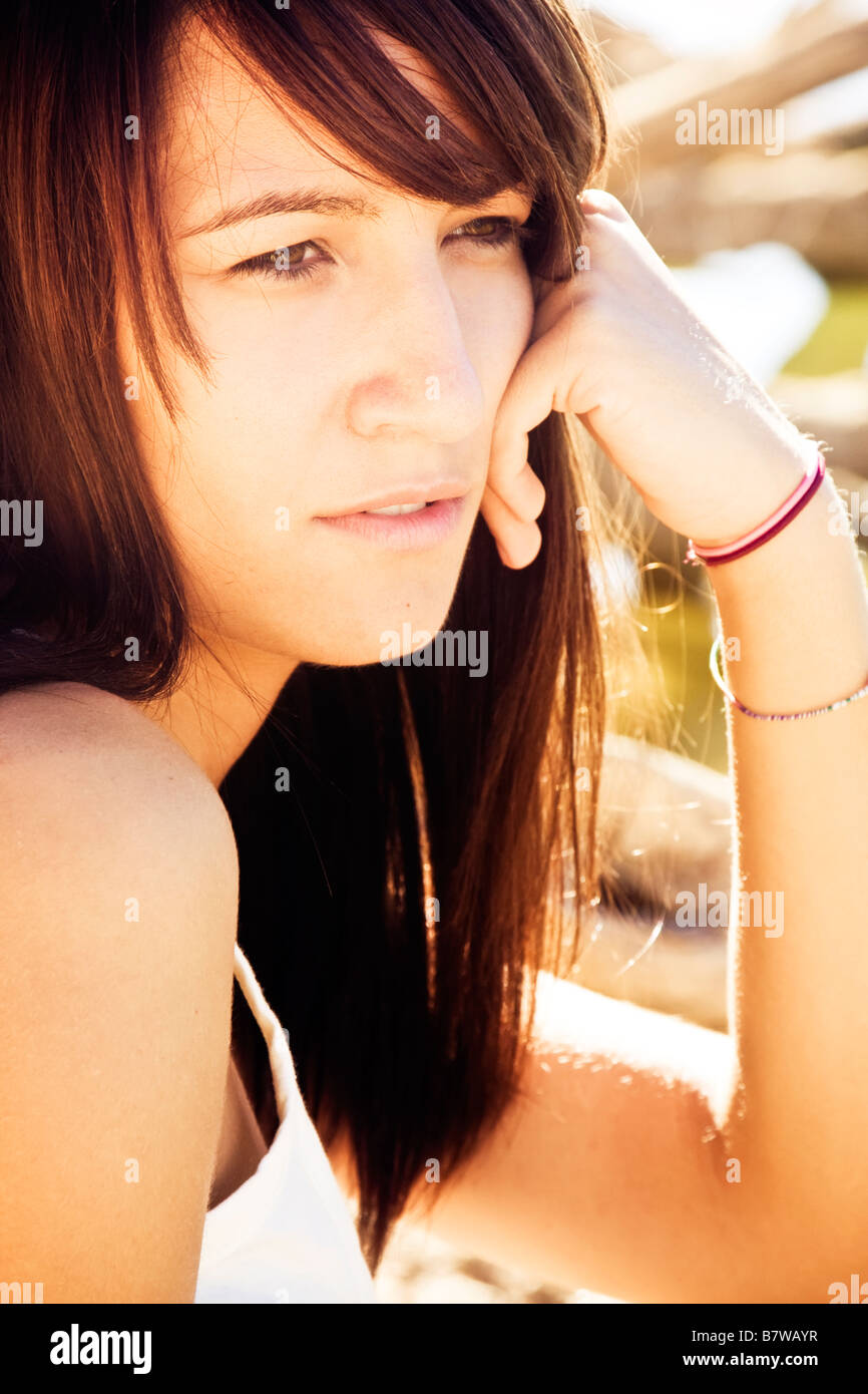 Thoughtful young woman portrait under sunlight Stock Photo - Alamy