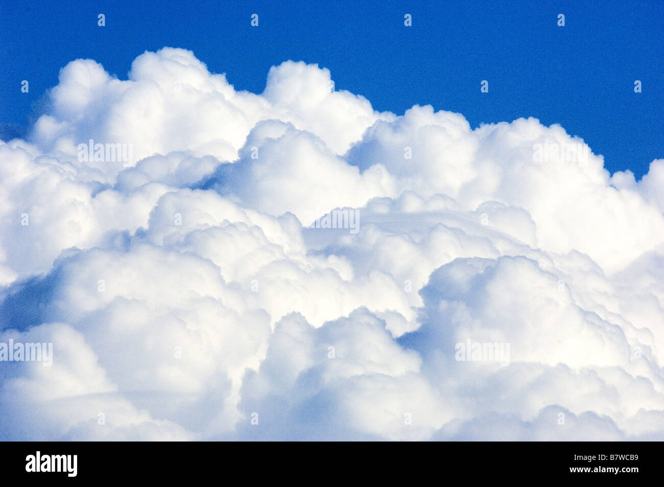 Billowing fluffy clouds billow up into the sky Stock Photo - Alamy