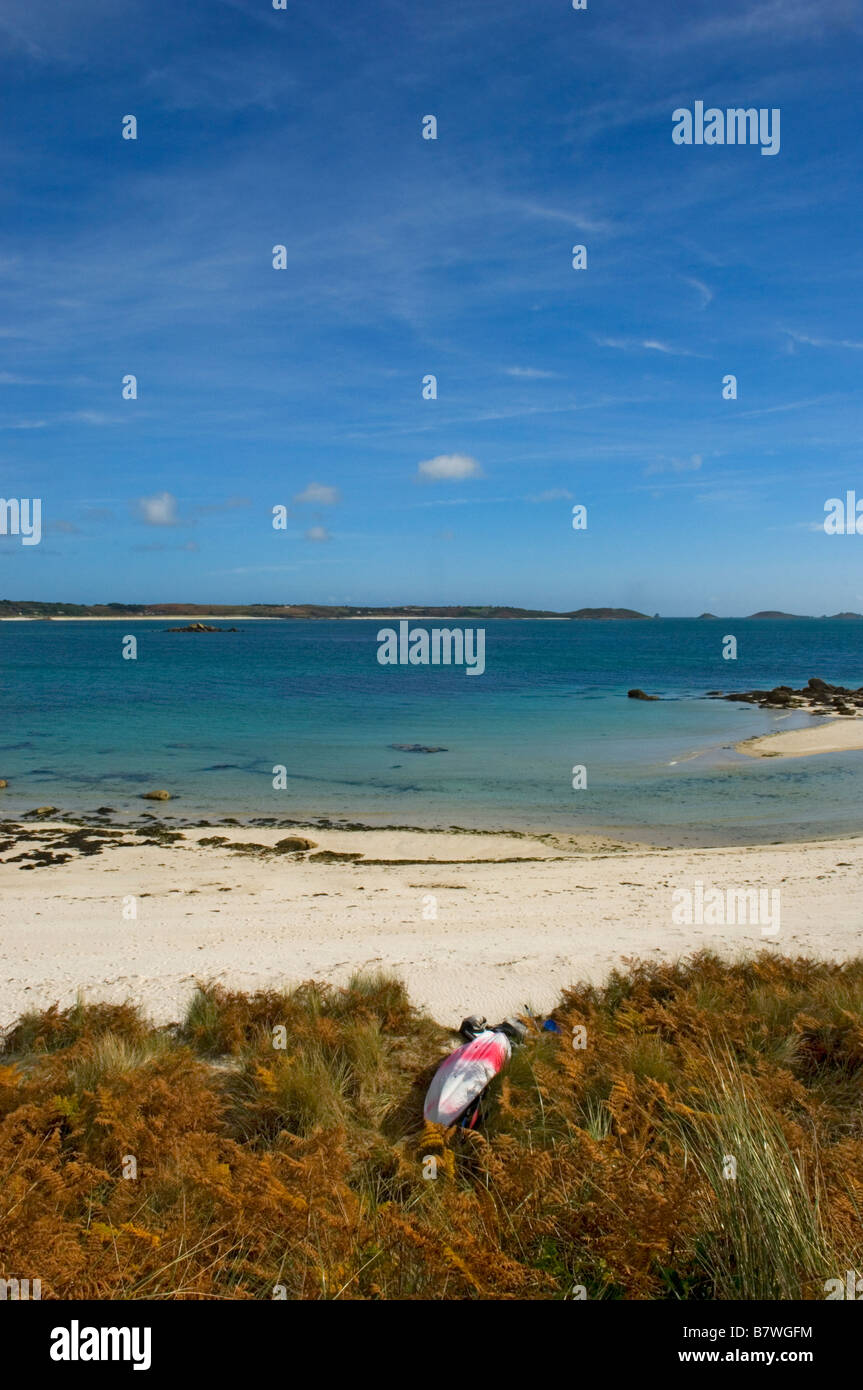 A single canoe lies on the empty white sandy beach of Pentle Bay Tresco ...