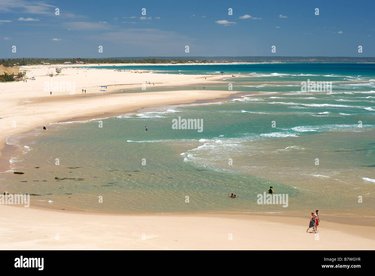Couple strolling along the coast at Barra beach near Inhambane in ...