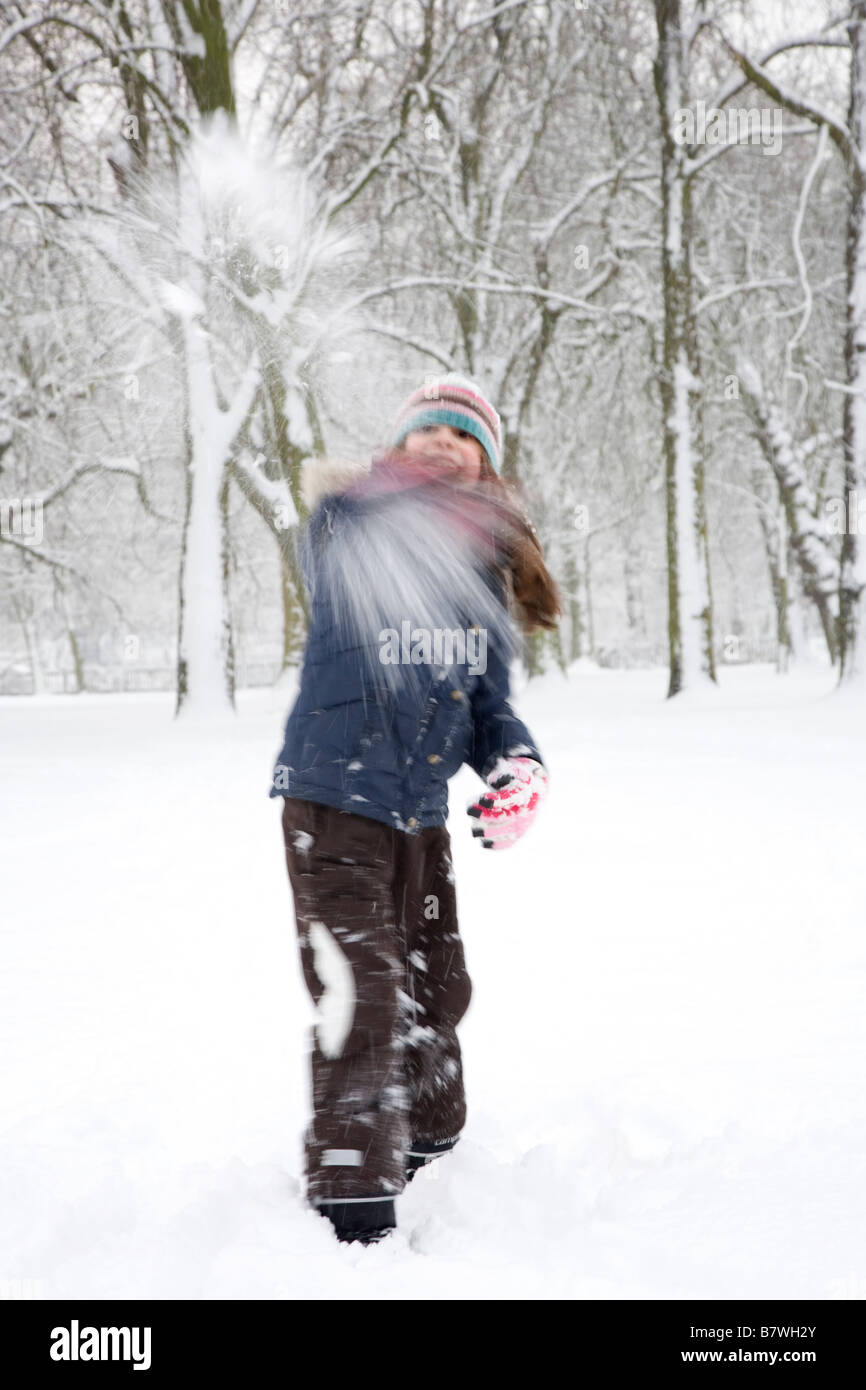 Young girl throwing snowball Stock Photo - Alamy