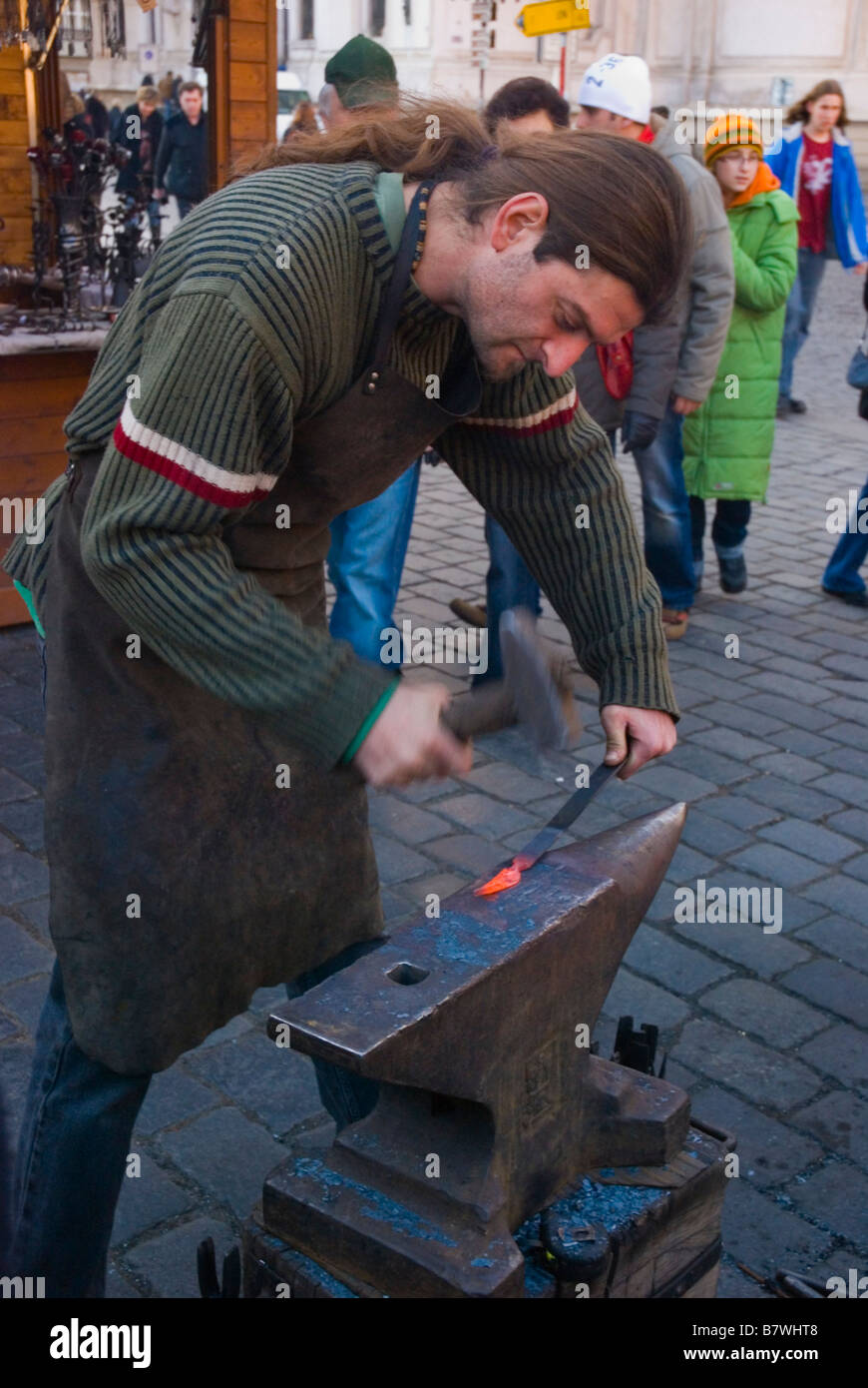 Ironmonger melting metal at Old Town Square Christmas market in Prague ...