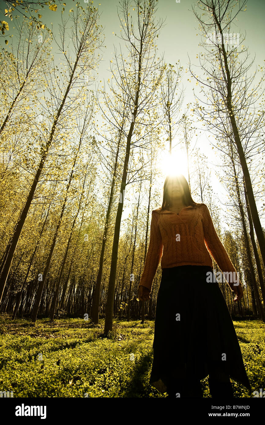 Young woman playing with the sun in the woods Stock Photo - Alamy