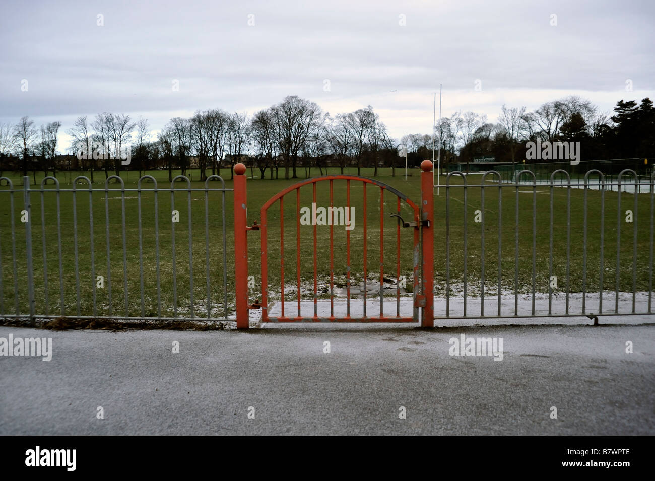 A fence with a red gate Stock Photo - Alamy