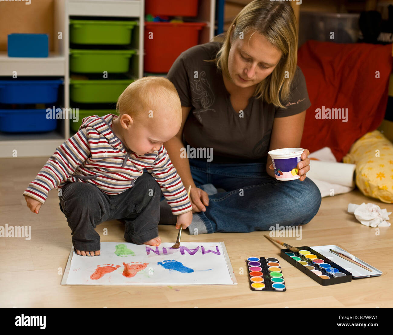 Baby girl and mother painting Germany September 2008 Stock Photo - Alamy