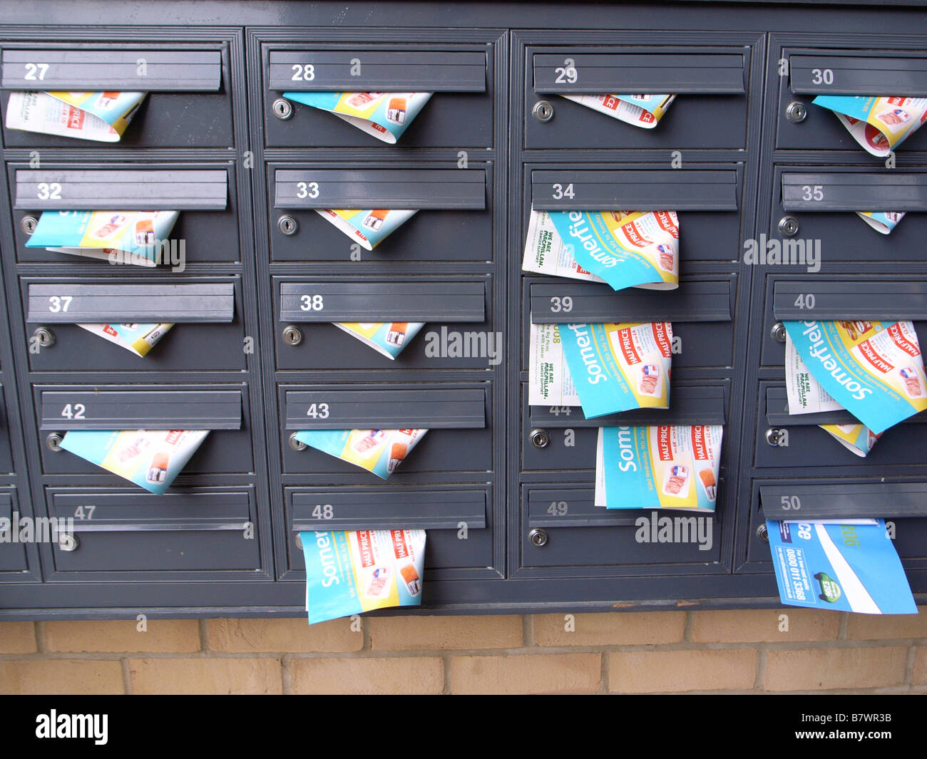 Junk mail in letterboxes, London Stock Photo - Alamy