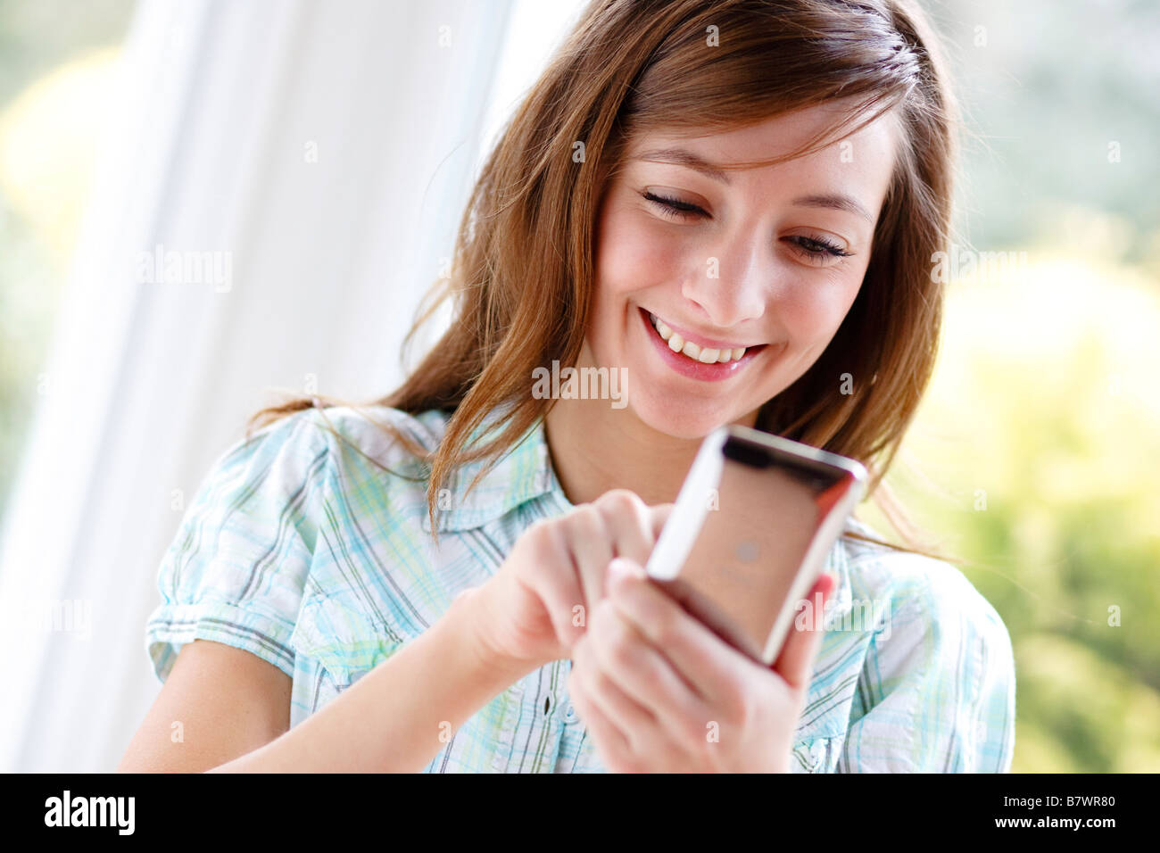 Girl using iPhone mobile phone Stock Photo - Alamy