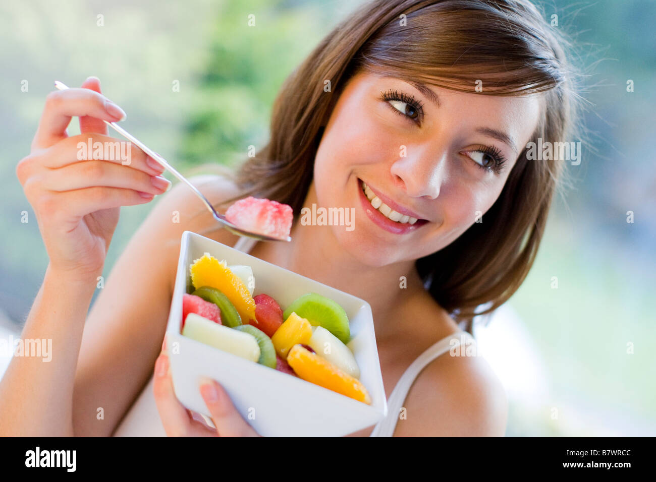 Girl eating fruit Stock Photo - Alamy