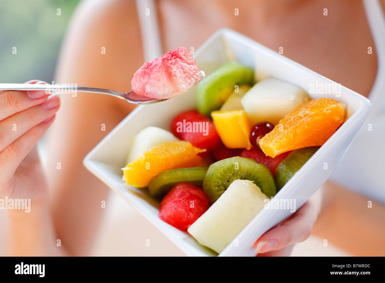 Girl eating fruit Stock Photo - Alamy
