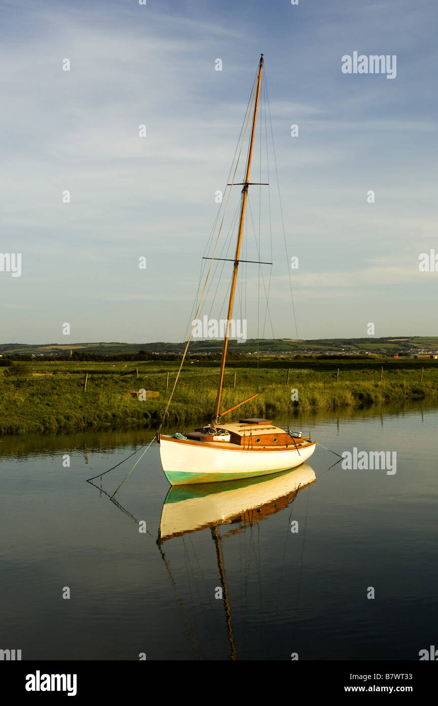 Moored sailing boat reflected at high tide on Velator inlet off the Taw ...