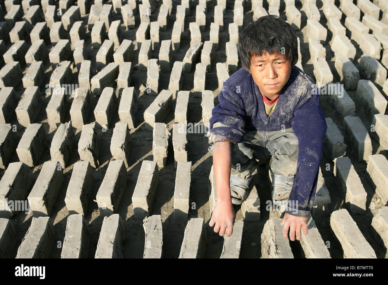 Ten year old brick worker Bose Stock Photo - Alamy