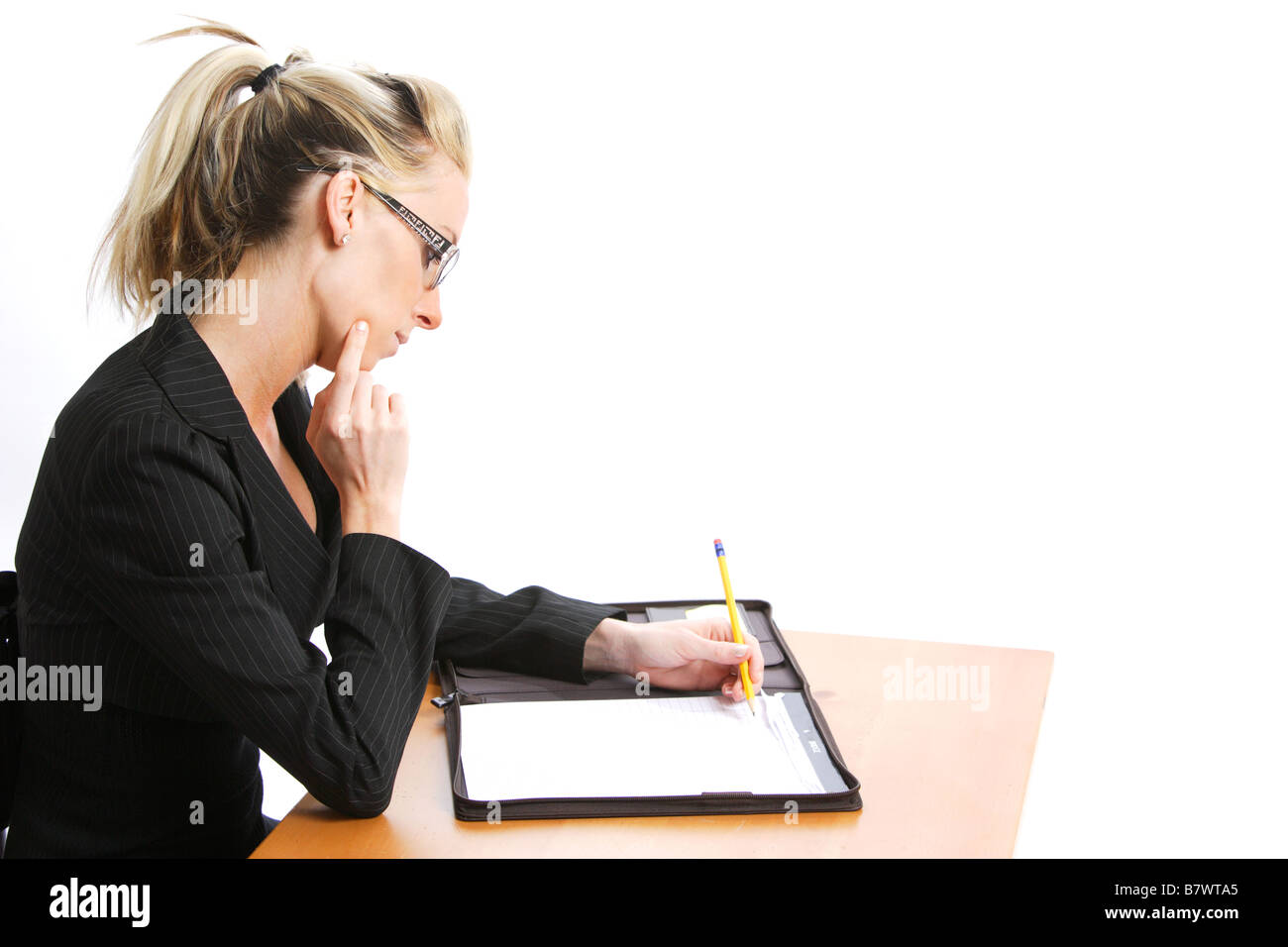 Business Woman sitting at a desk working Stock Photo - Alamy