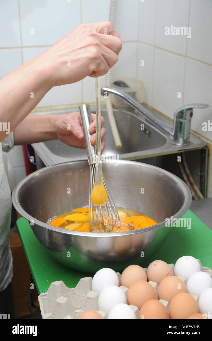 A Cook beating eggs Stock Photo - Alamy
