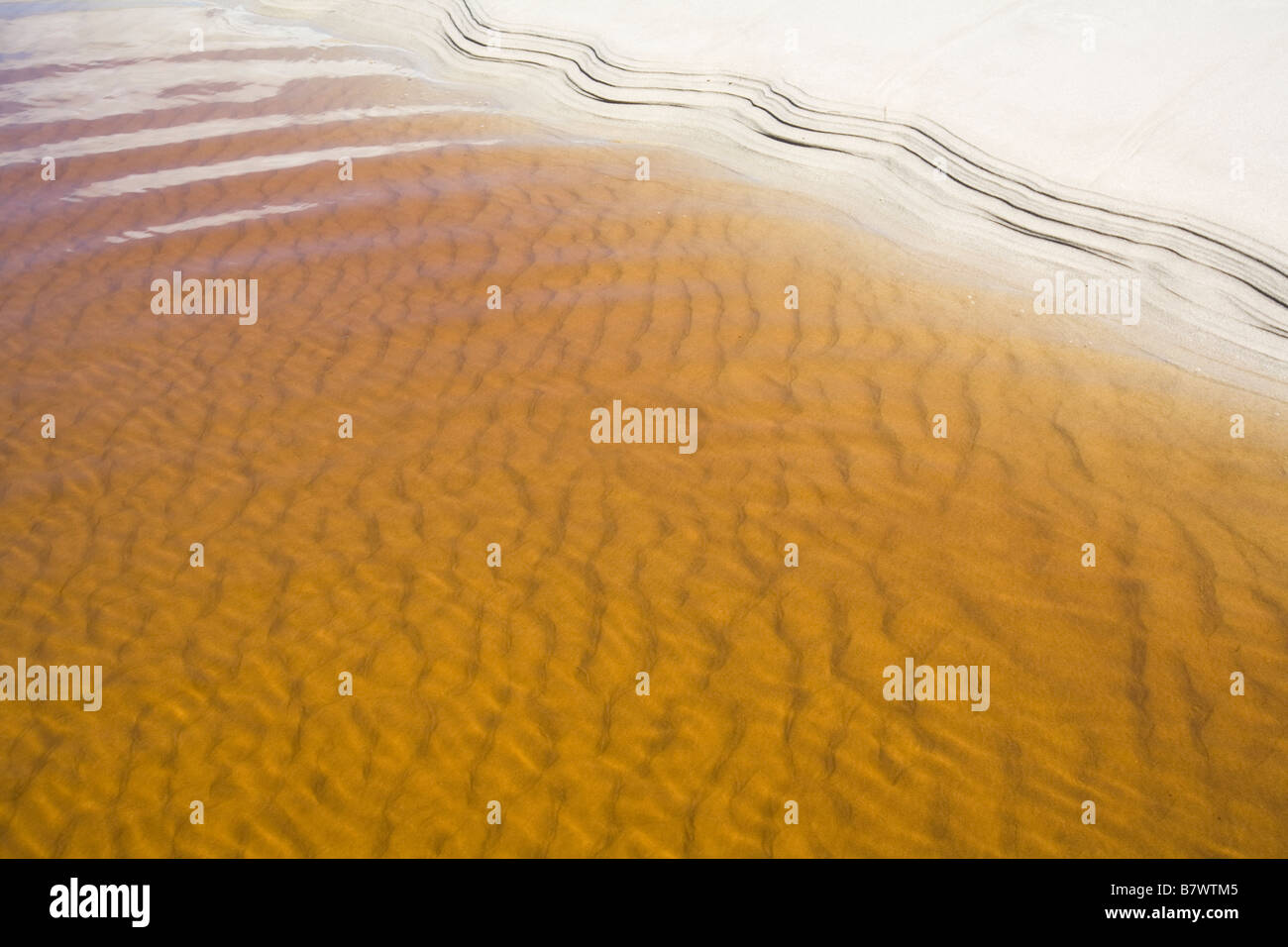 Detail of sand and water pattern at beach Stock Photo - Alamy