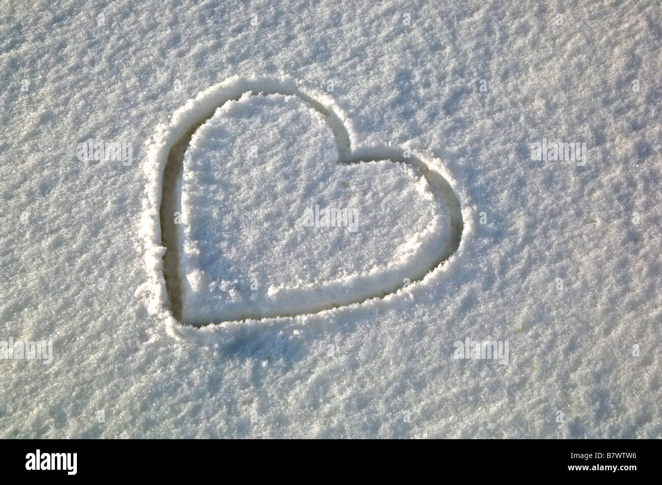 Heart drawn in snow Stock Photo - Alamy
