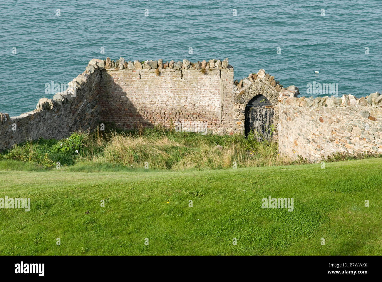 Stonewall between lawn and the sea, Howth Peninsula, Dublin Ireland ...