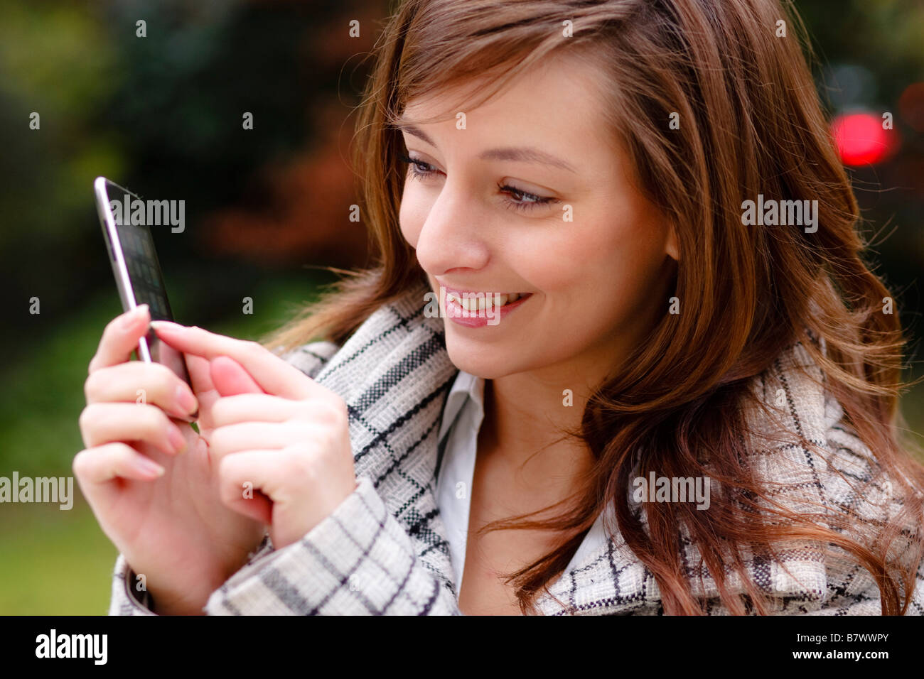 Girl using iPhone mobile phone Stock Photo - Alamy