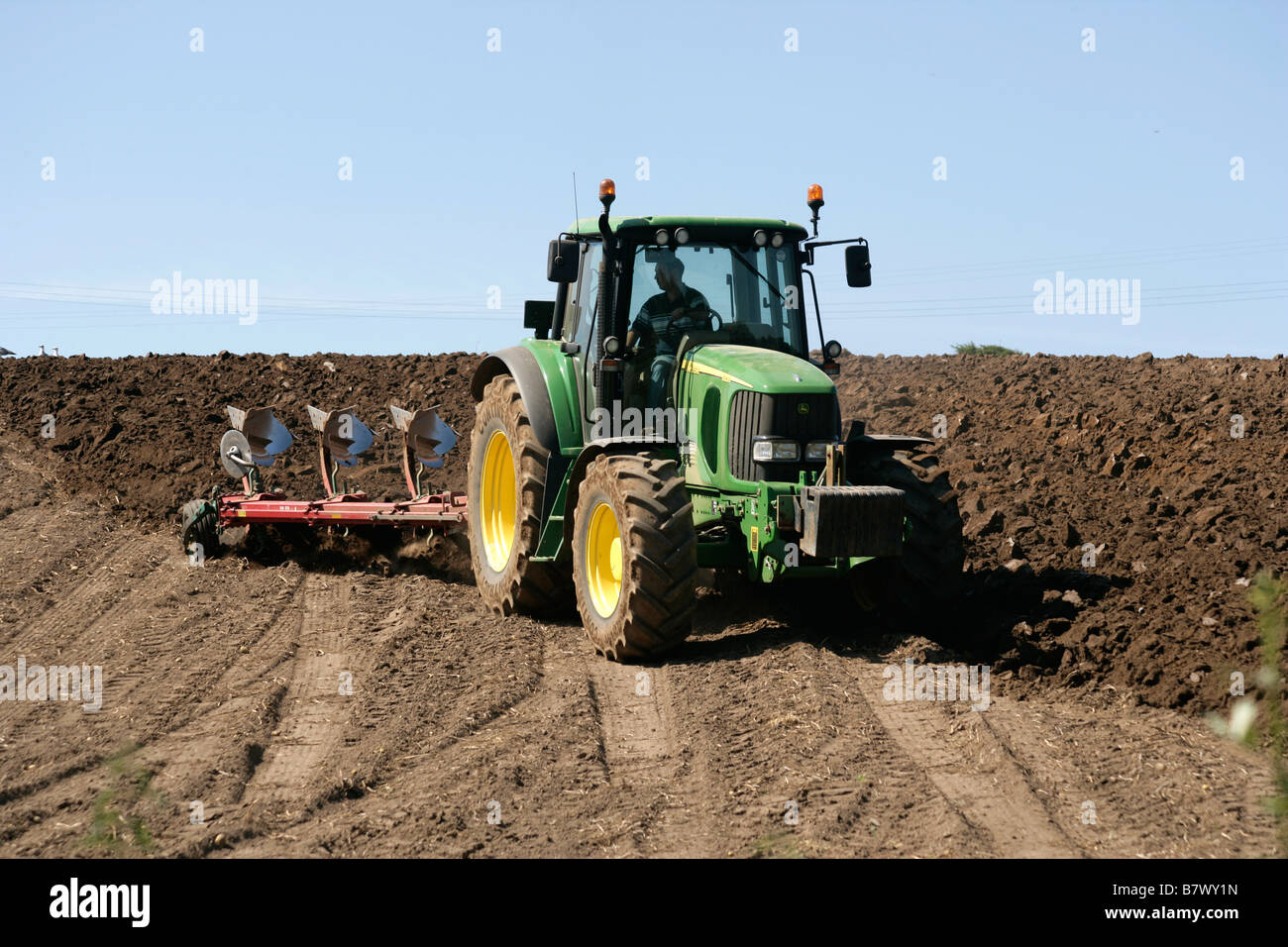 tractor ploughing harvested potato field, Cornwall UK Stock Photo - Alamy