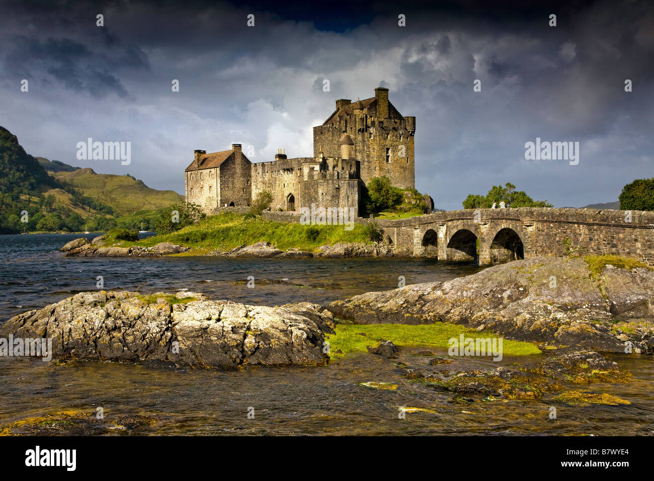 The dramatic castle at Eileen Donan as the storm clouds roll in with ...