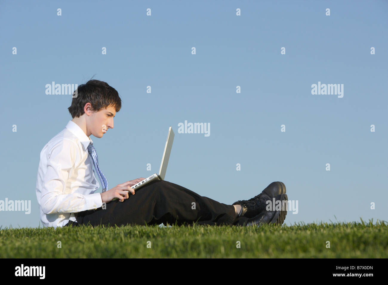 A Business man working outside in a park Stock Photo - Alamy