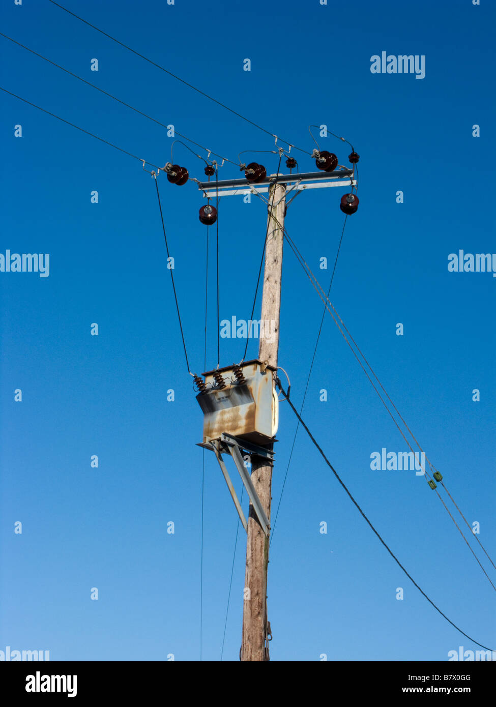 Electric pole against blue sky Stock Photo - Alamy