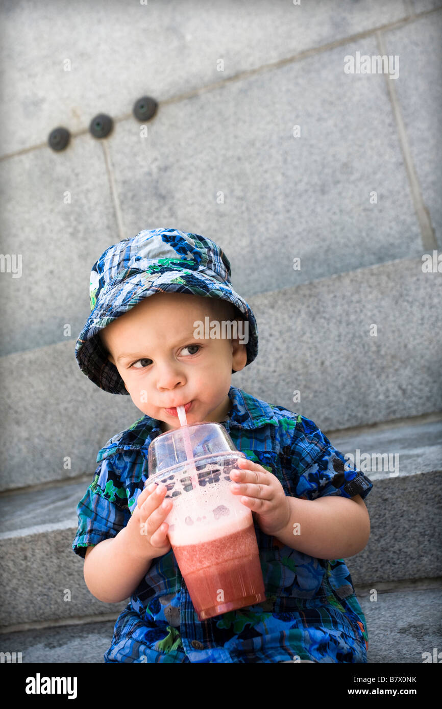 Boy drinking iced fruity drink Stock Photo - Alamy